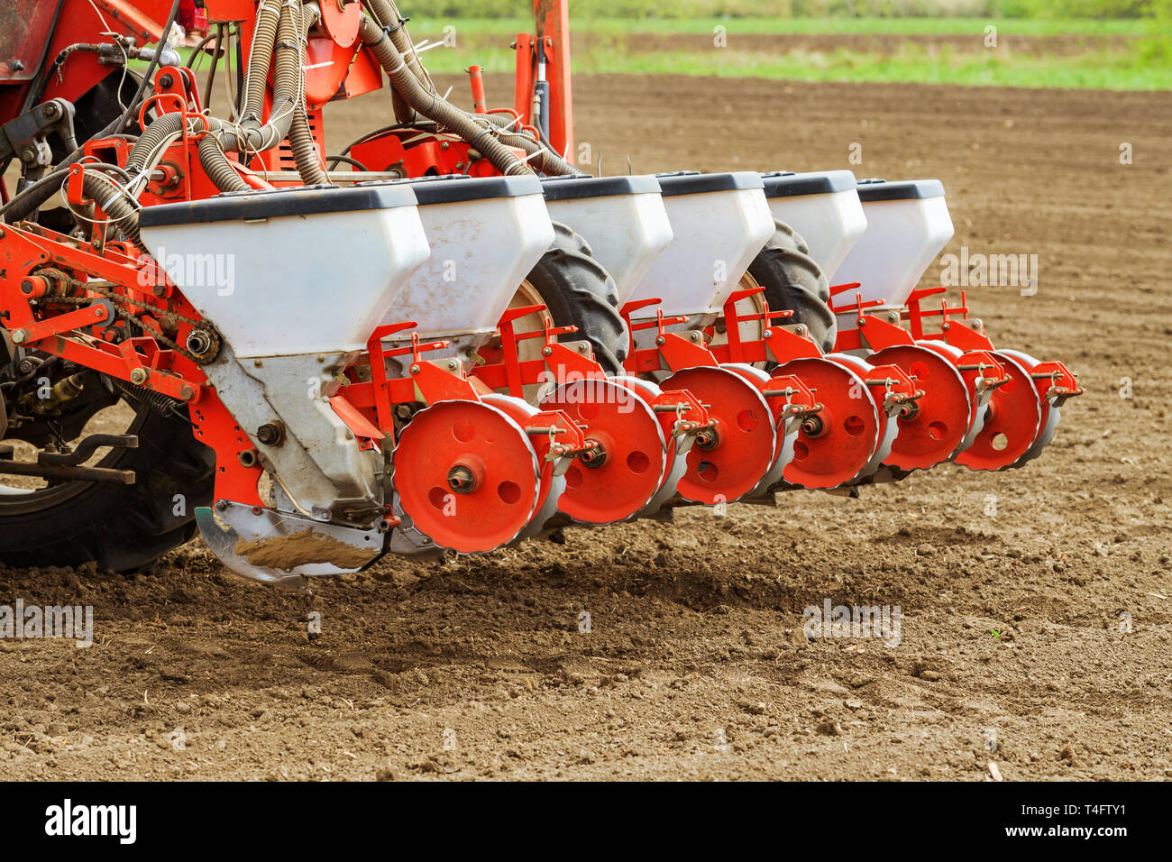 Tractor with mounted crop seeder planting corn seed in field Stock ...