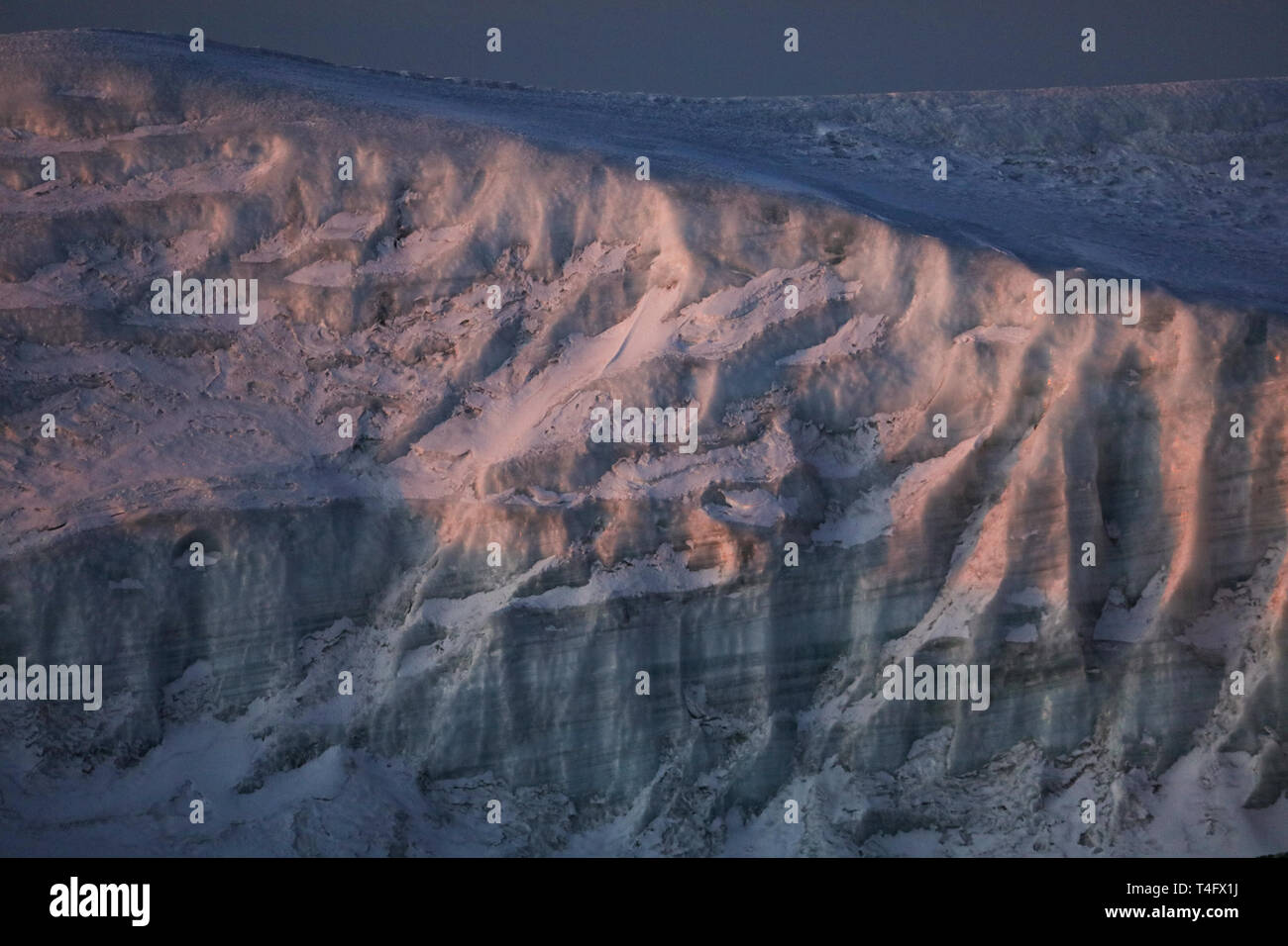 Close picture of an iceberg, texture of an ice layers and snow cover ...