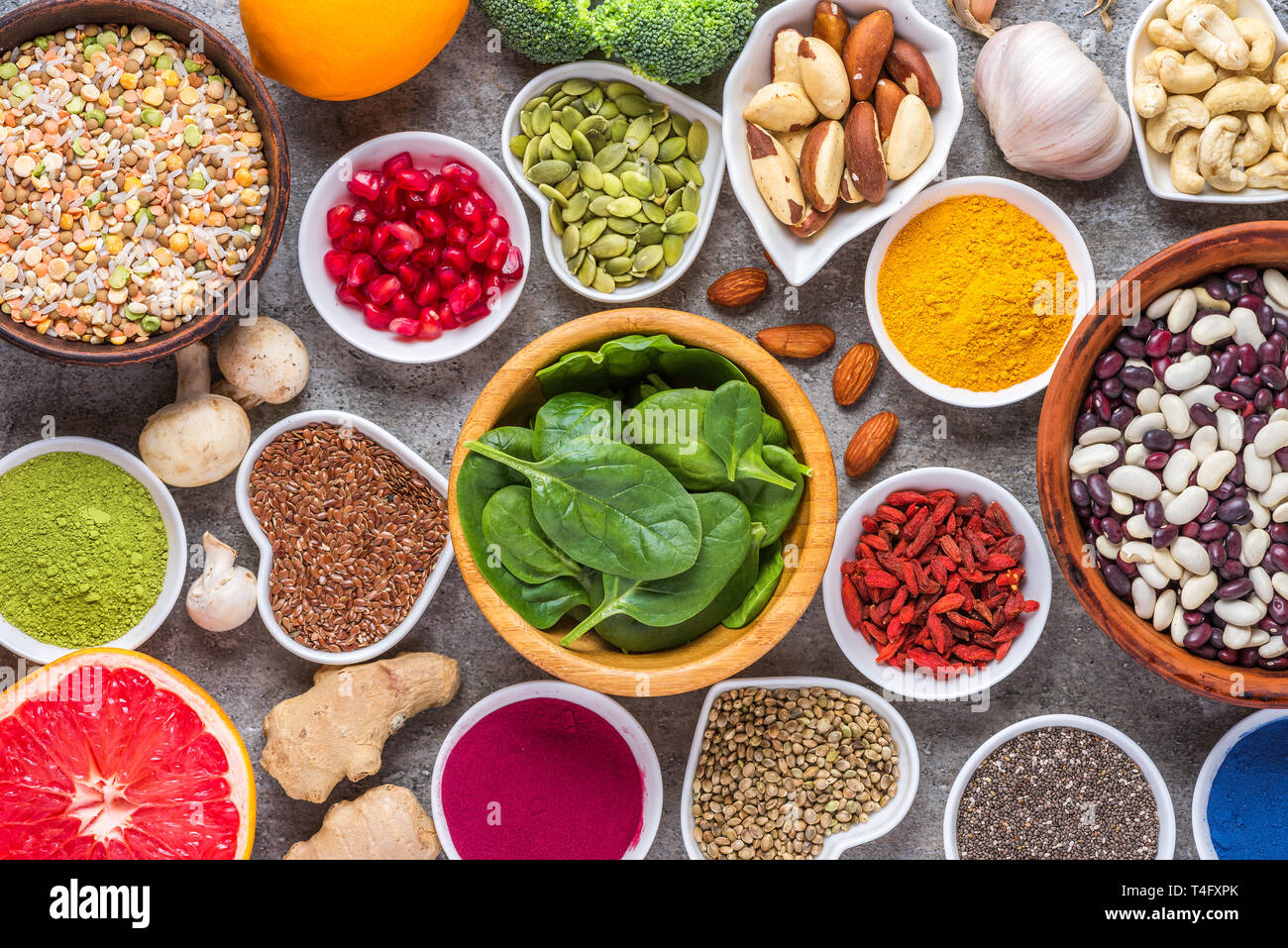 assortment of healthy vegan food on concrete background. vegetables ...