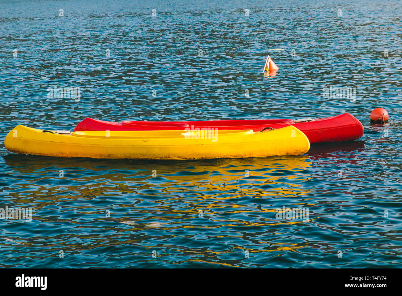 two kayaks red and yellow in water. summer leisure Stock Photo - Alamy
