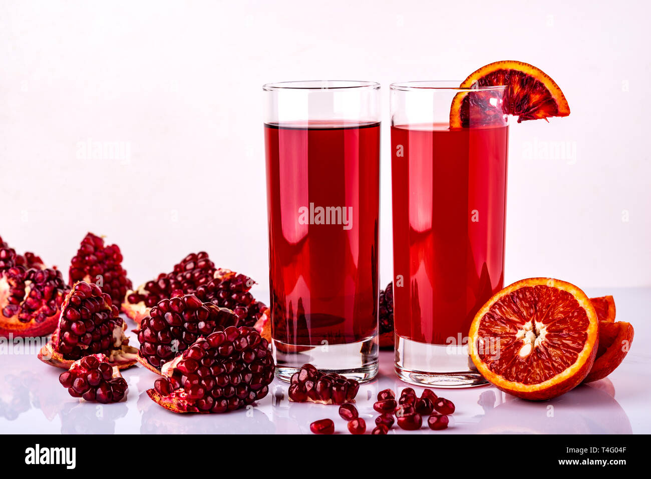 Set of healthy fresh red color drinks on the white background. Raw ...