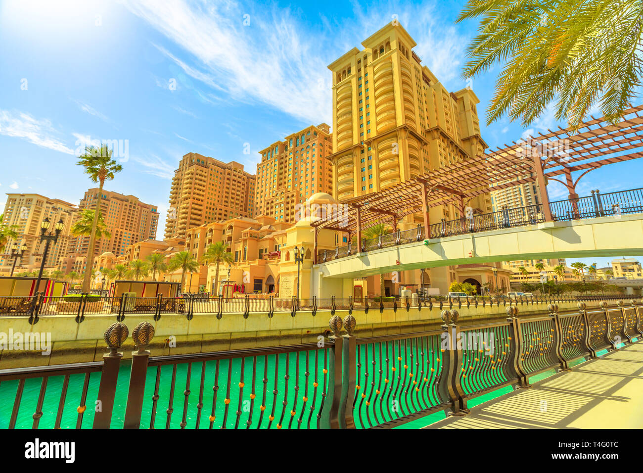 Pedestrian bridge above canals of lagoon of Porto Arabia marina, the ...