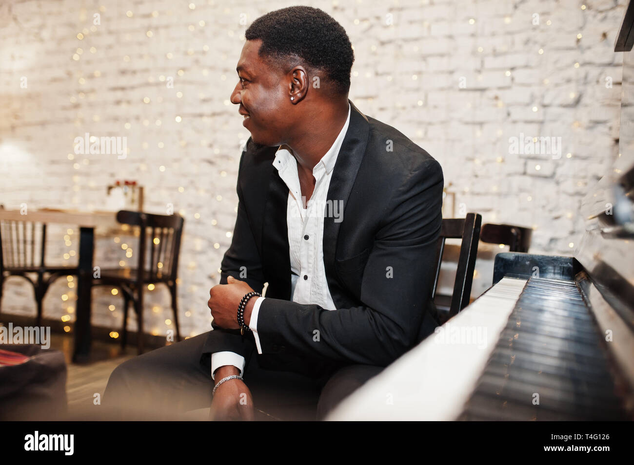 Strong powerful african american man in black suit sitting against ...