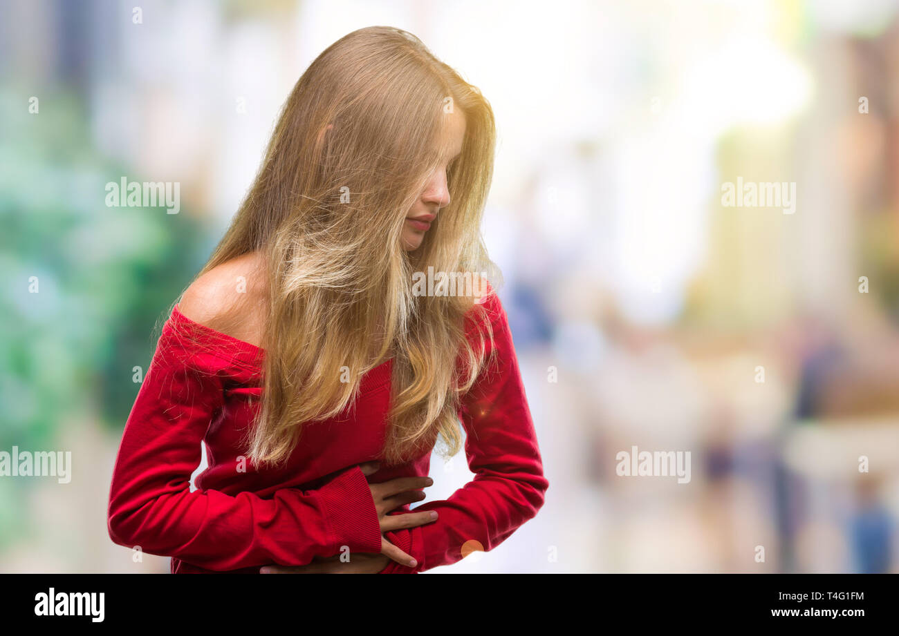 Young beautiful blonde woman wearing red sweater over isolated ...