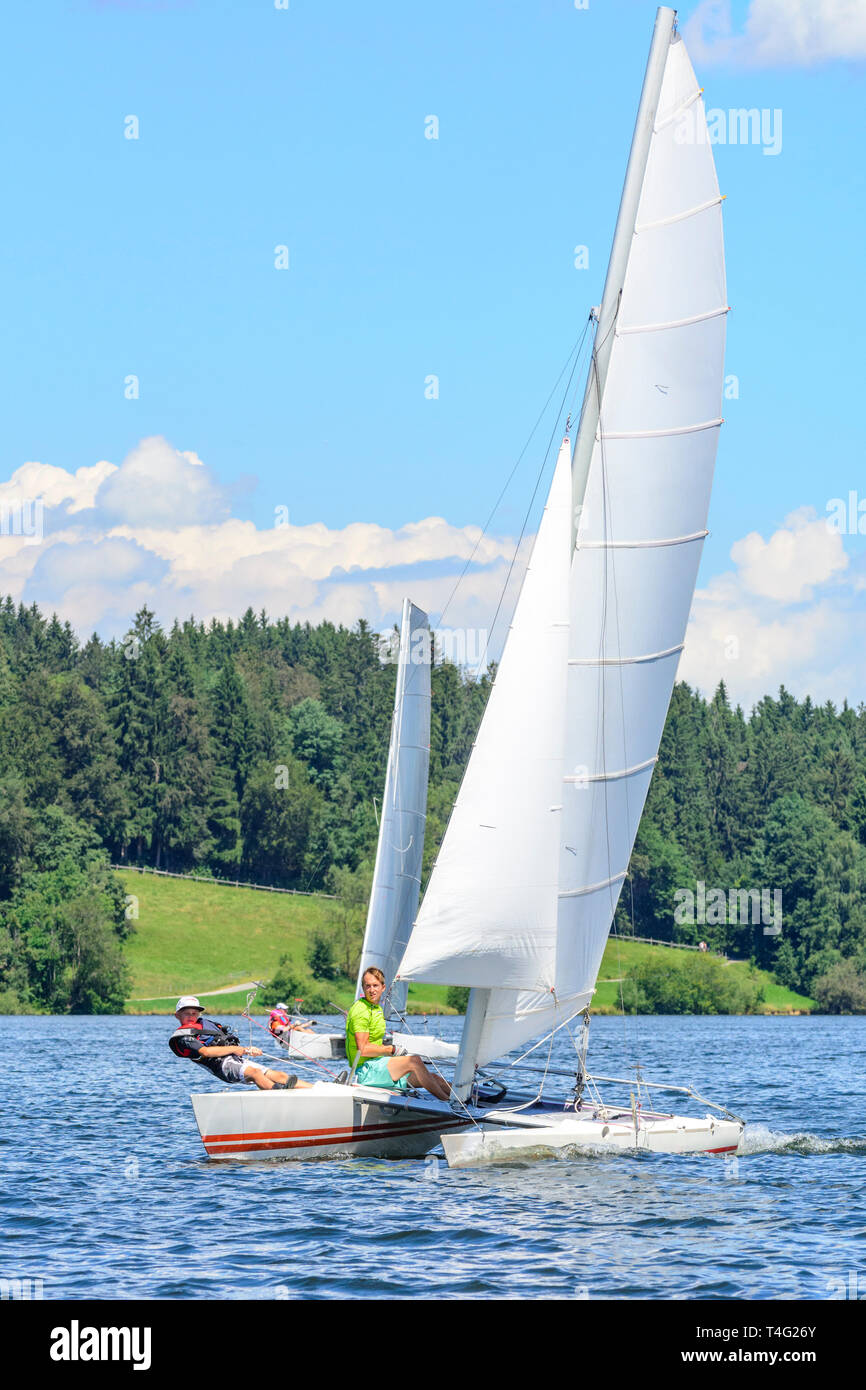 Catamaran sailing on inland lake in summertime Stock Photo - Alamy
