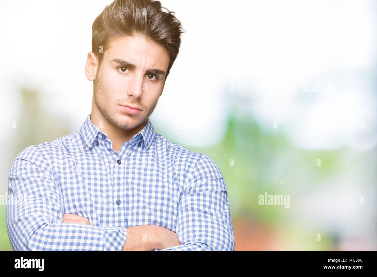 Young handsome business man over isolated background skeptic and ...