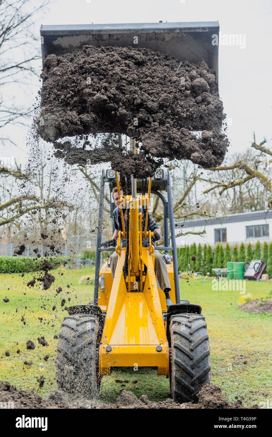 Rough earthworks using a wheel loader Stock Photo - Alamy