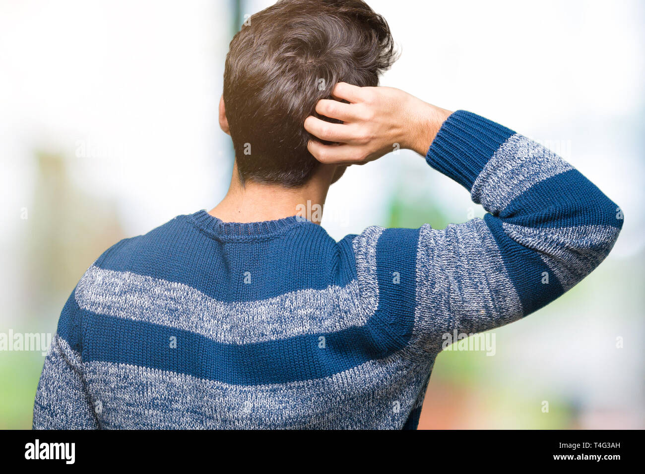 Young handsome man over isolated background Backwards thinking about ...