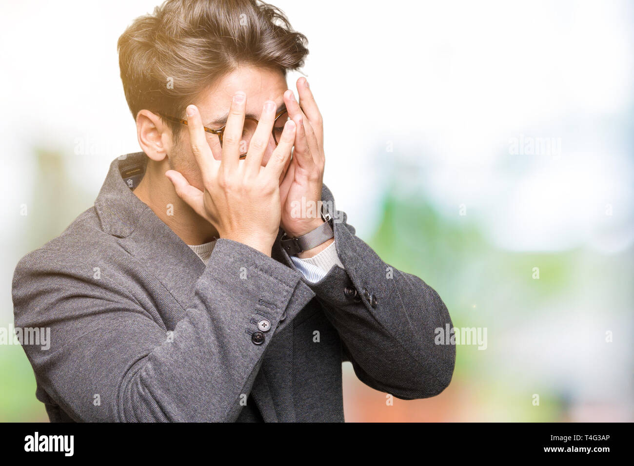 Young business man wearing glasses over isolated background with sad ...