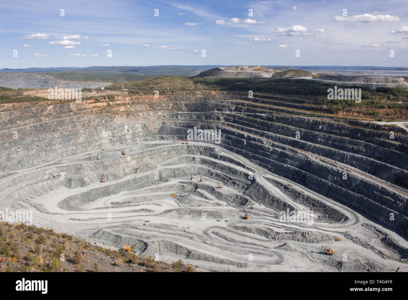 Aerial view industrial of opencast mining quarry with lots of machinery ...