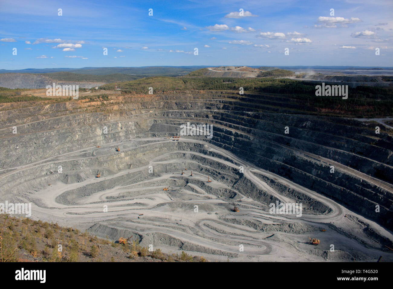 Aerial view industrial of opencast mining quarry with lots of machinery ...