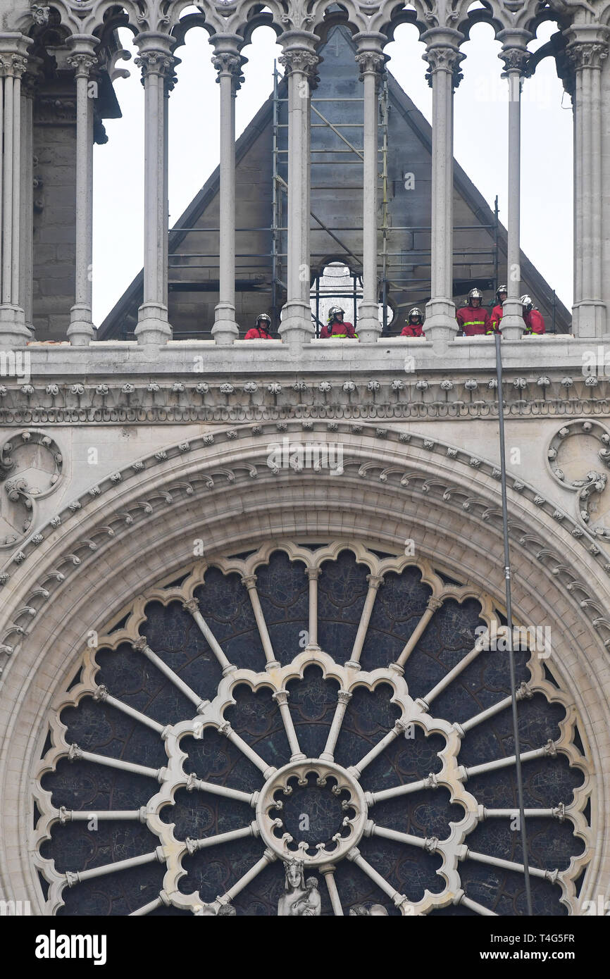 Firefighters assess the damage to the Notre Dame Cathedral in Paris ...
