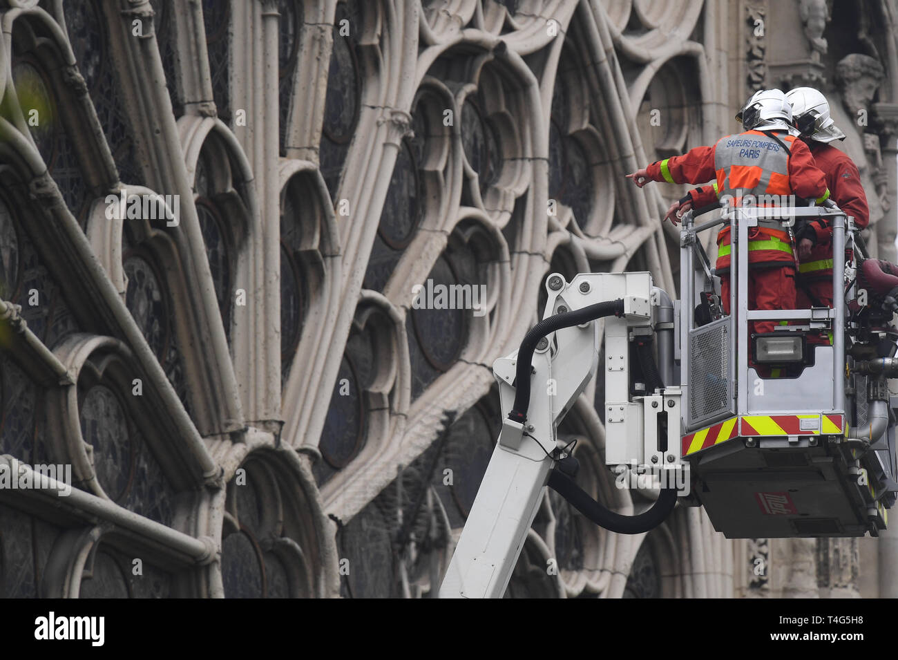 Firefighters assess the damage to the Notre Dame Cathedral in Paris ...