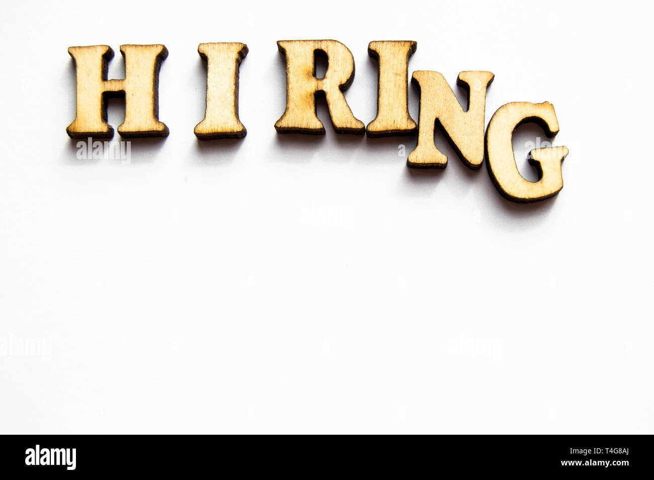 The word hiring is written in gold letters, isolated on white ...