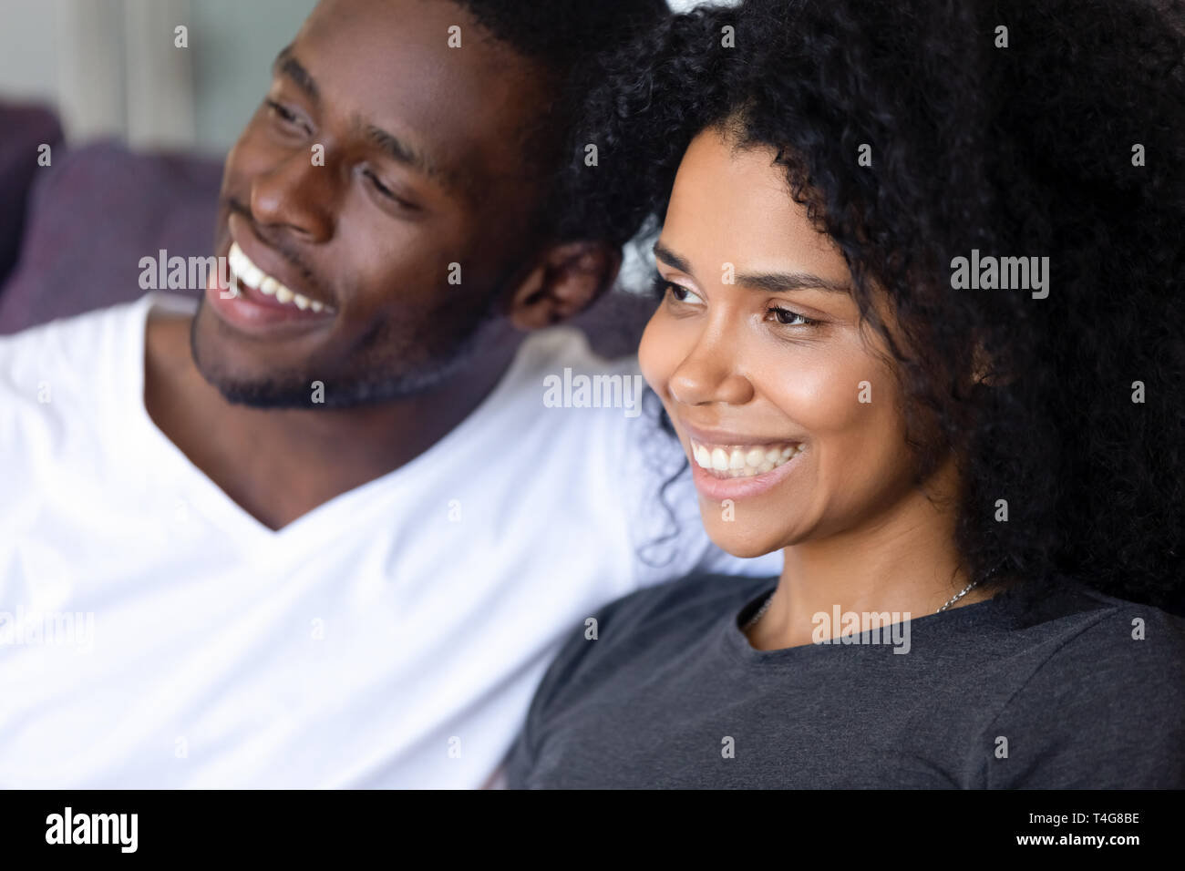 Couple sitting together on sofa hi-res stock photography and images - Alamy