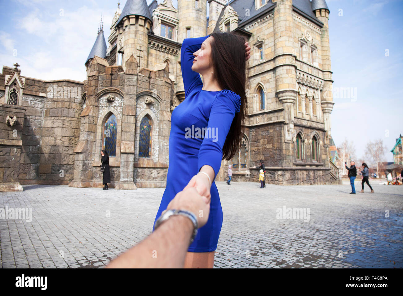 Follow me. Portrait young beautiful brunette woman in summer dress ...