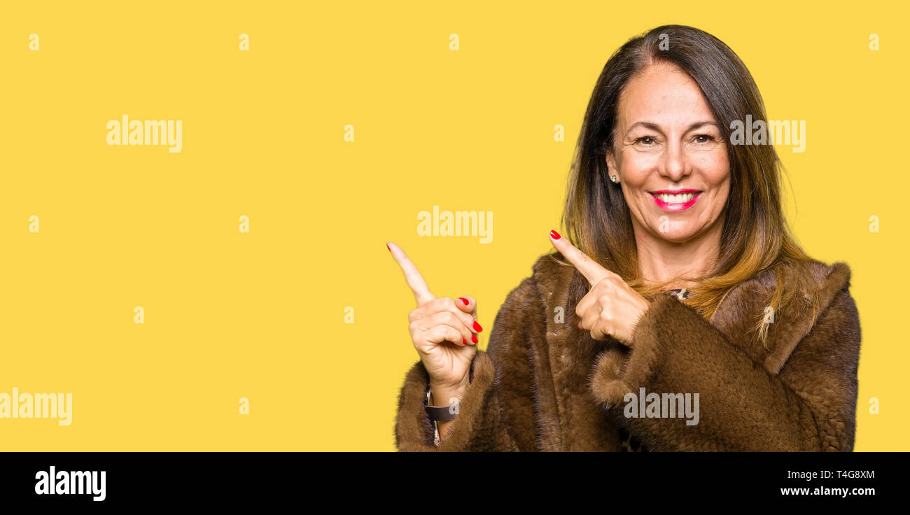 Beautiful middle age elegant woman wearing mink coat smiling and ...