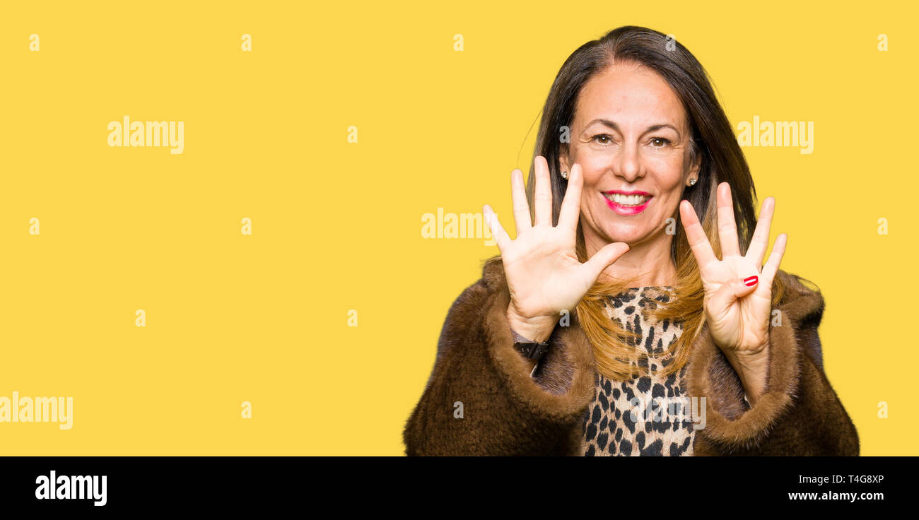 Beautiful middle age elegant woman wearing mink coat showing and ...