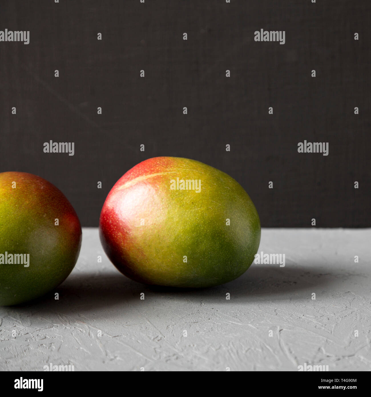 Two colorful sweet mangoes, side view. Closeup Stock Photo - Alamy