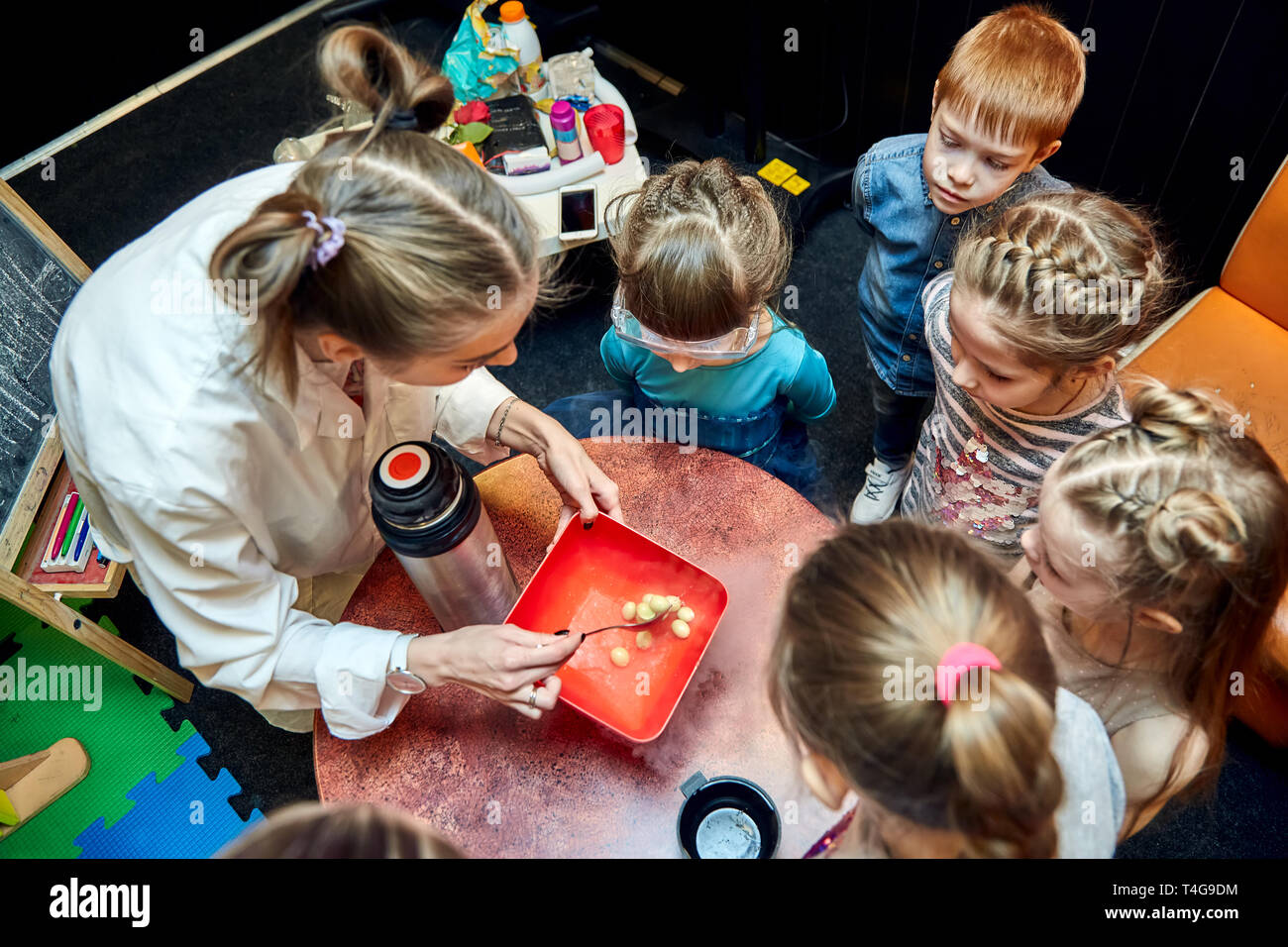Chemical show for kids. Professor carried out chemical experiments with ...