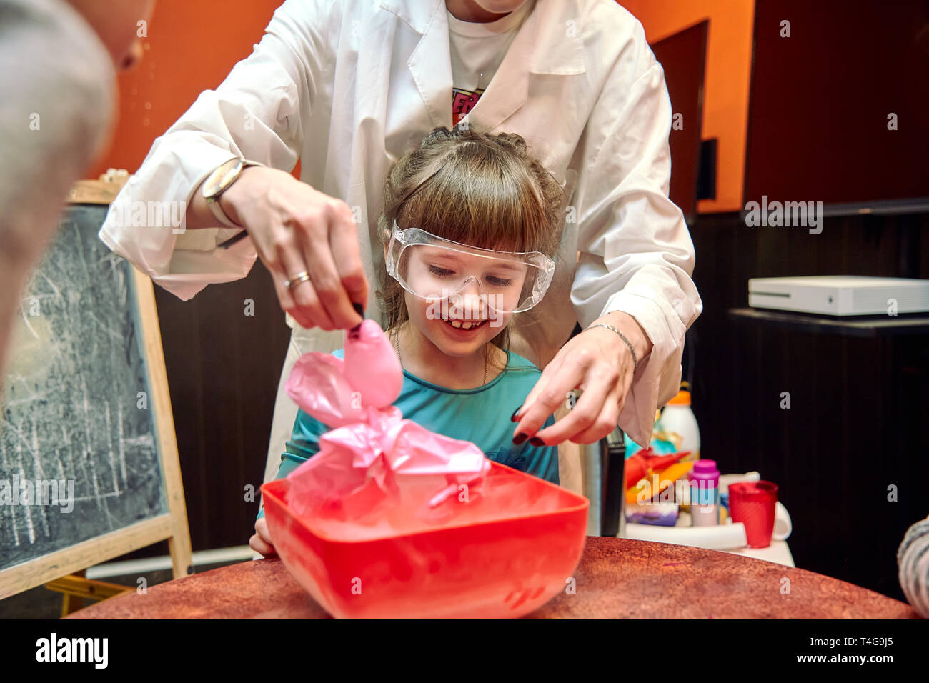 Chemical show for kids. Professor carried out chemical experiments with ...