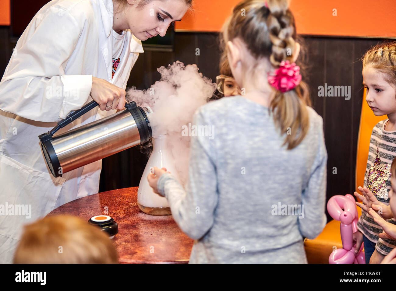 Chemical show for kids. Professor carried out chemical experiments with ...