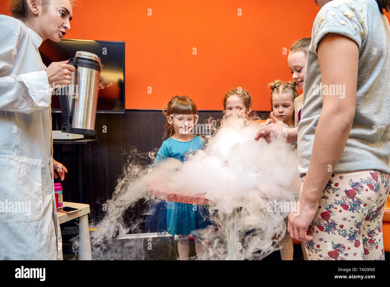 Chemical show for kids. Professor carried out chemical experiments with ...