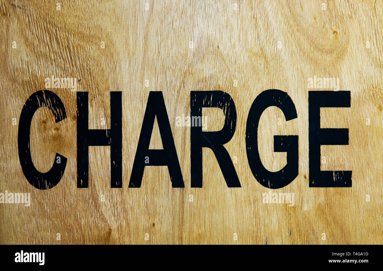 Word charge printed on old brown wood box Stock Photo - Alamy