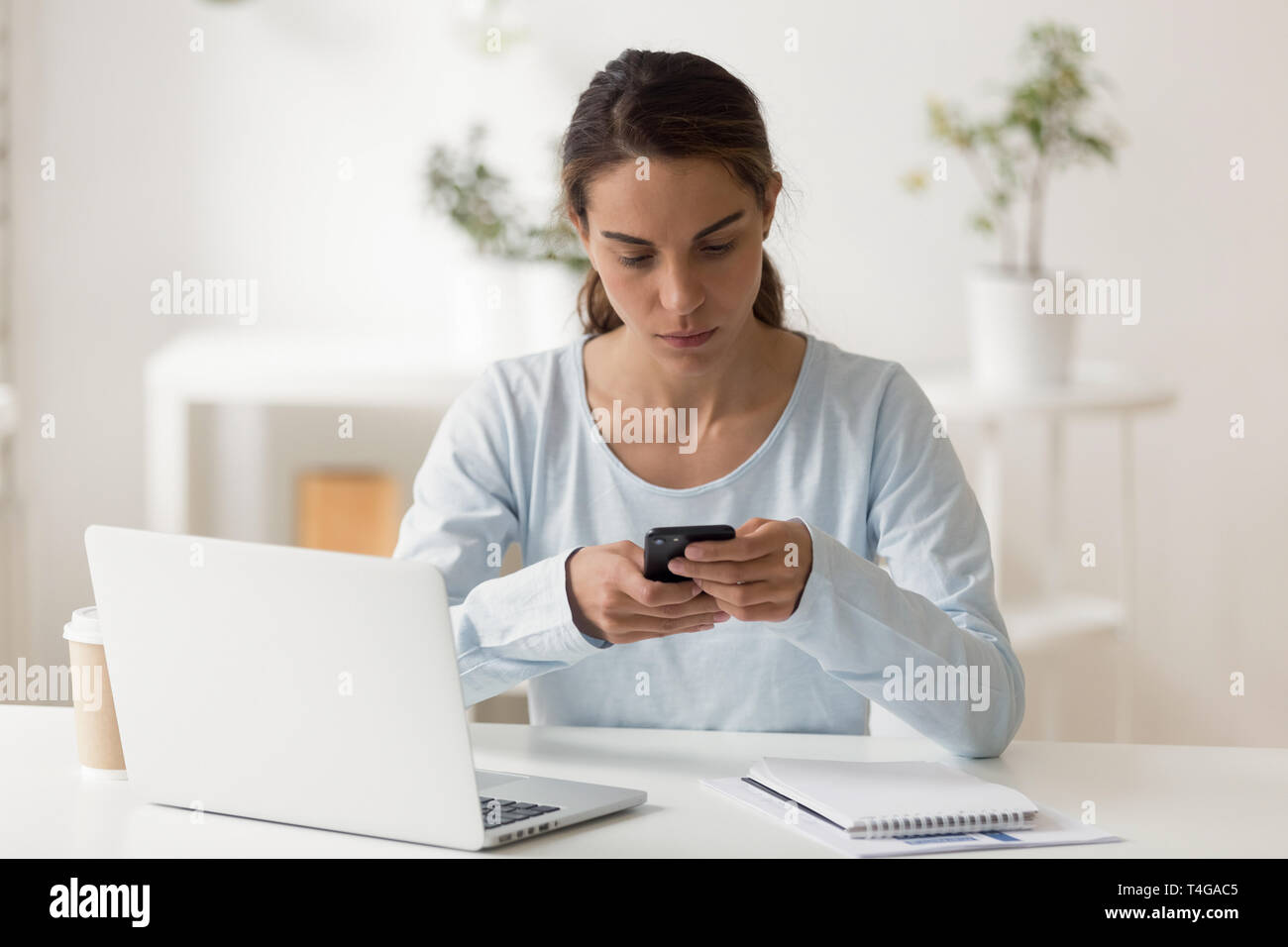 Beautiful woman typing message on her mobile device Stock Photo - Alamy