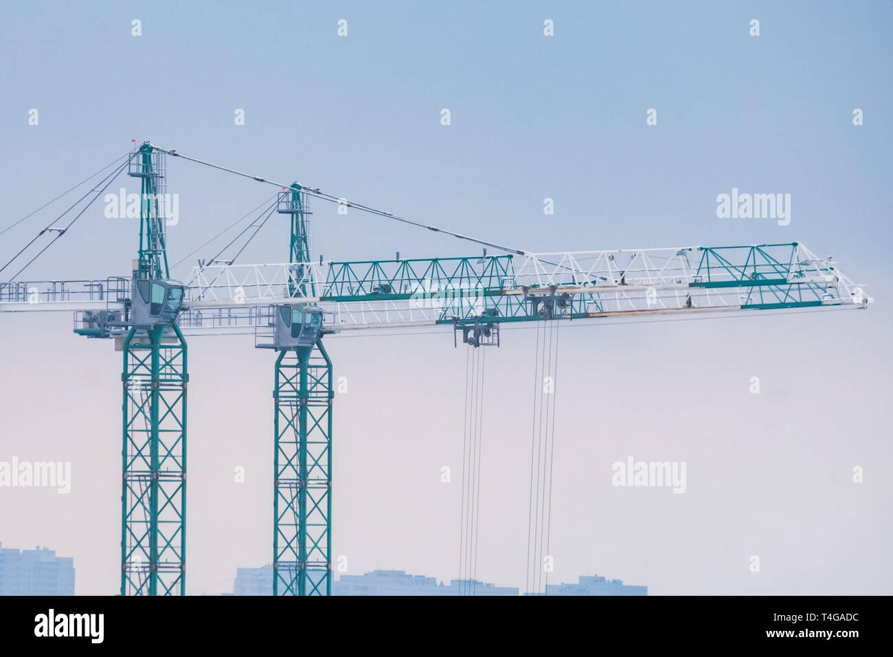 Construction of the new building. Two cranes in winter Stock Photo - Alamy
