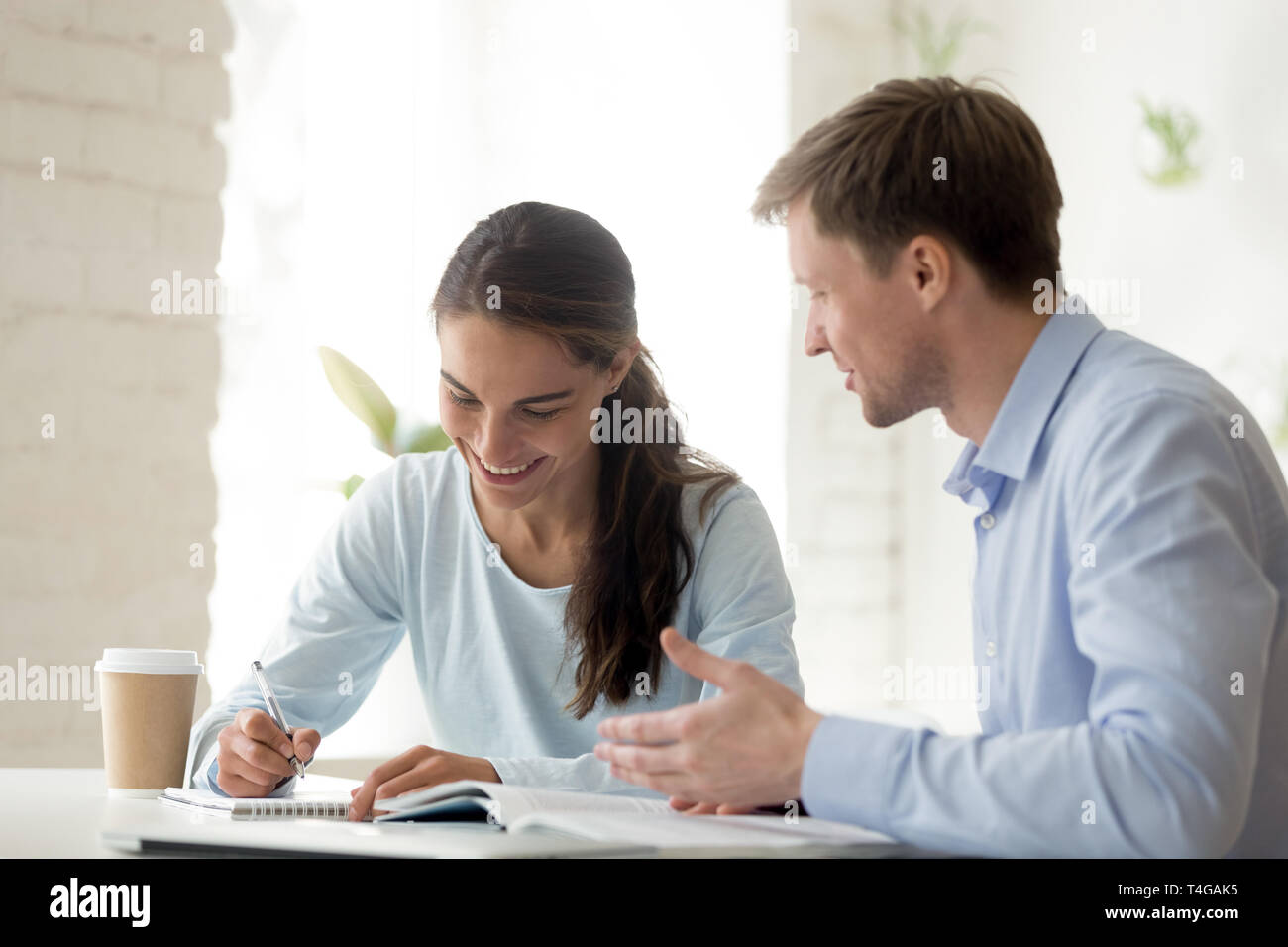 Teacher and female student having fun learning Stock Photo - Alamy