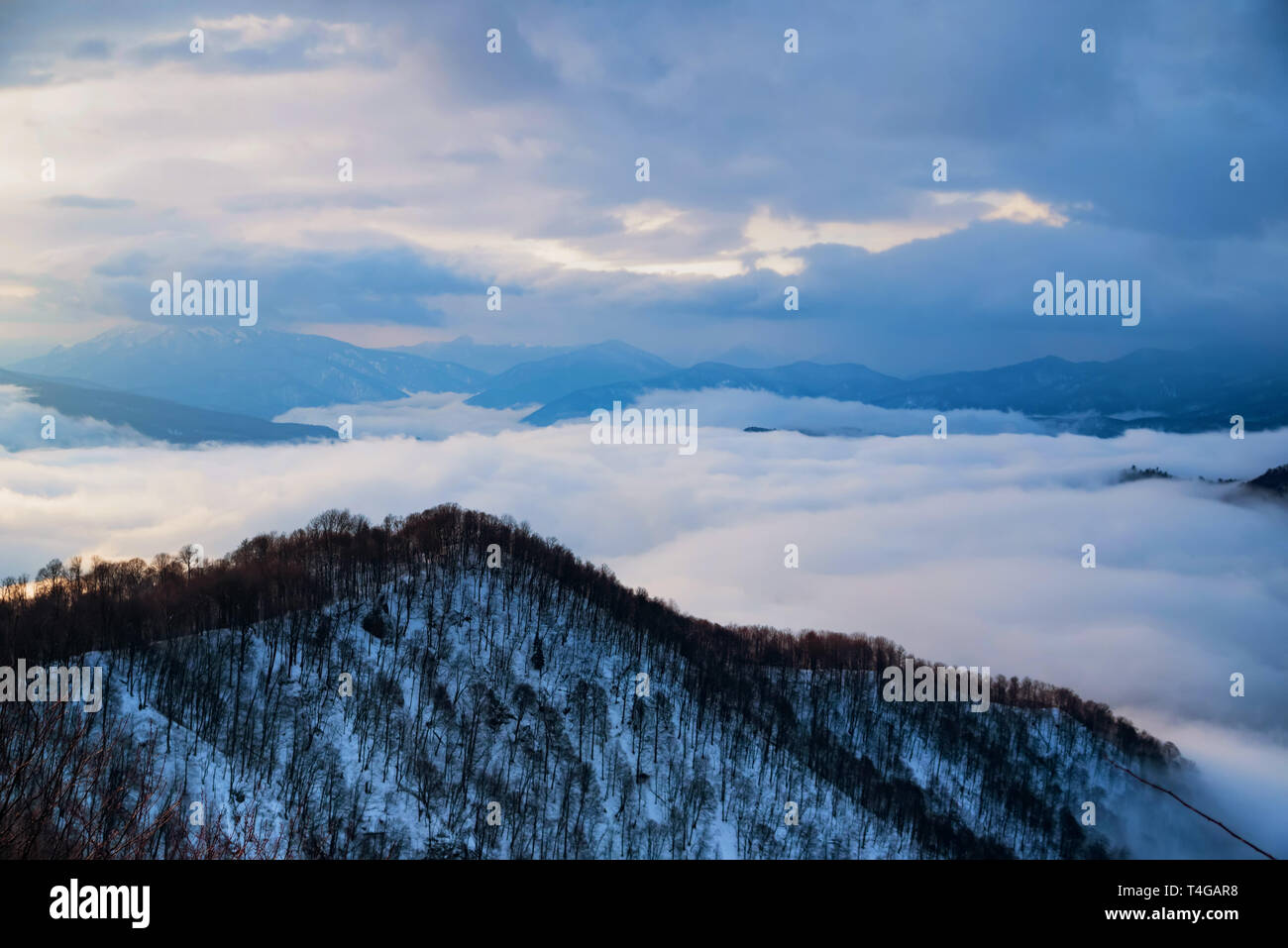 Beautiful distant winter mountains and skyscape with mist Stock Photo ...