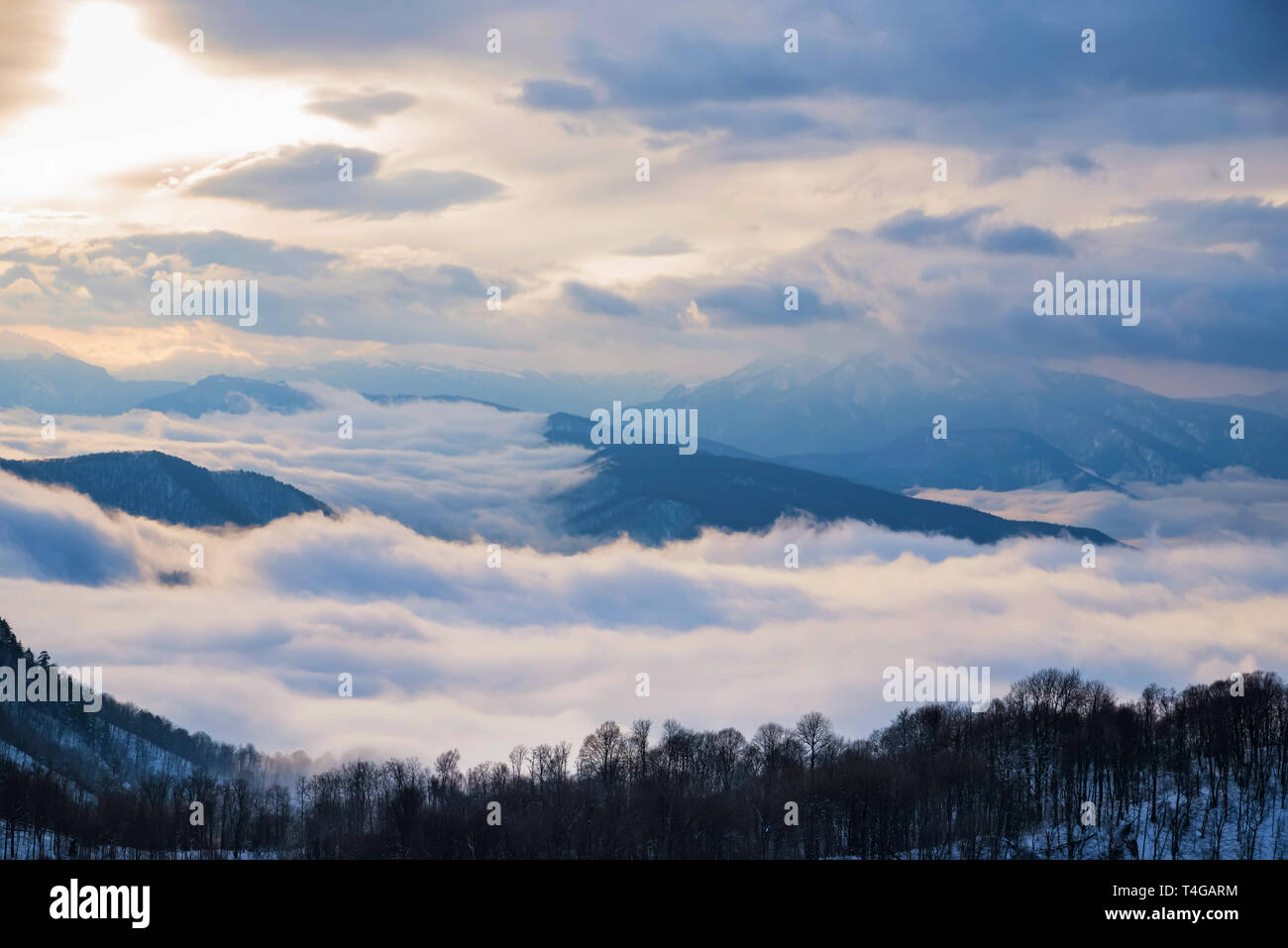 Beautiful distant winter mountains and skyscape with mist Stock Photo ...