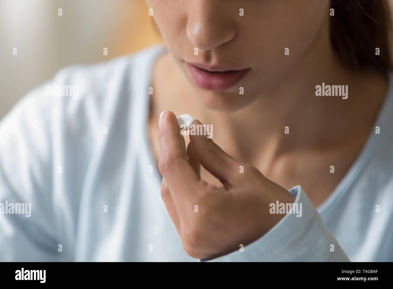 Woman with pill in mouth hi-res stock photography and images - Alamy