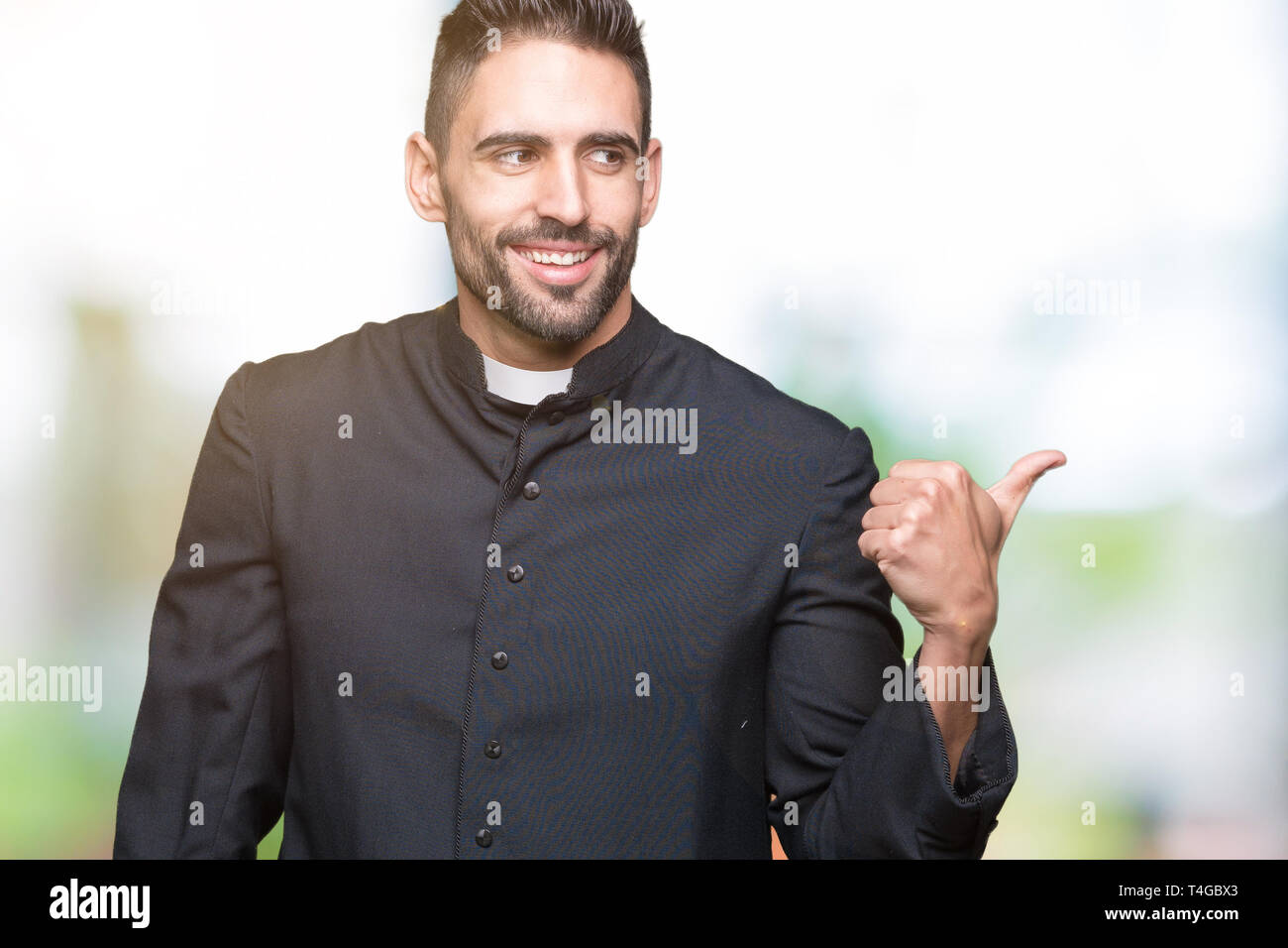 Young Christian priest over isolated background smiling with happy face ...