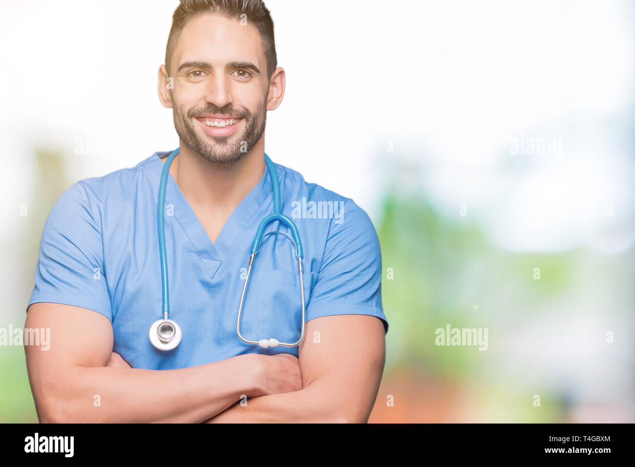 Handsome young doctor surgeon man over isolated background happy face ...