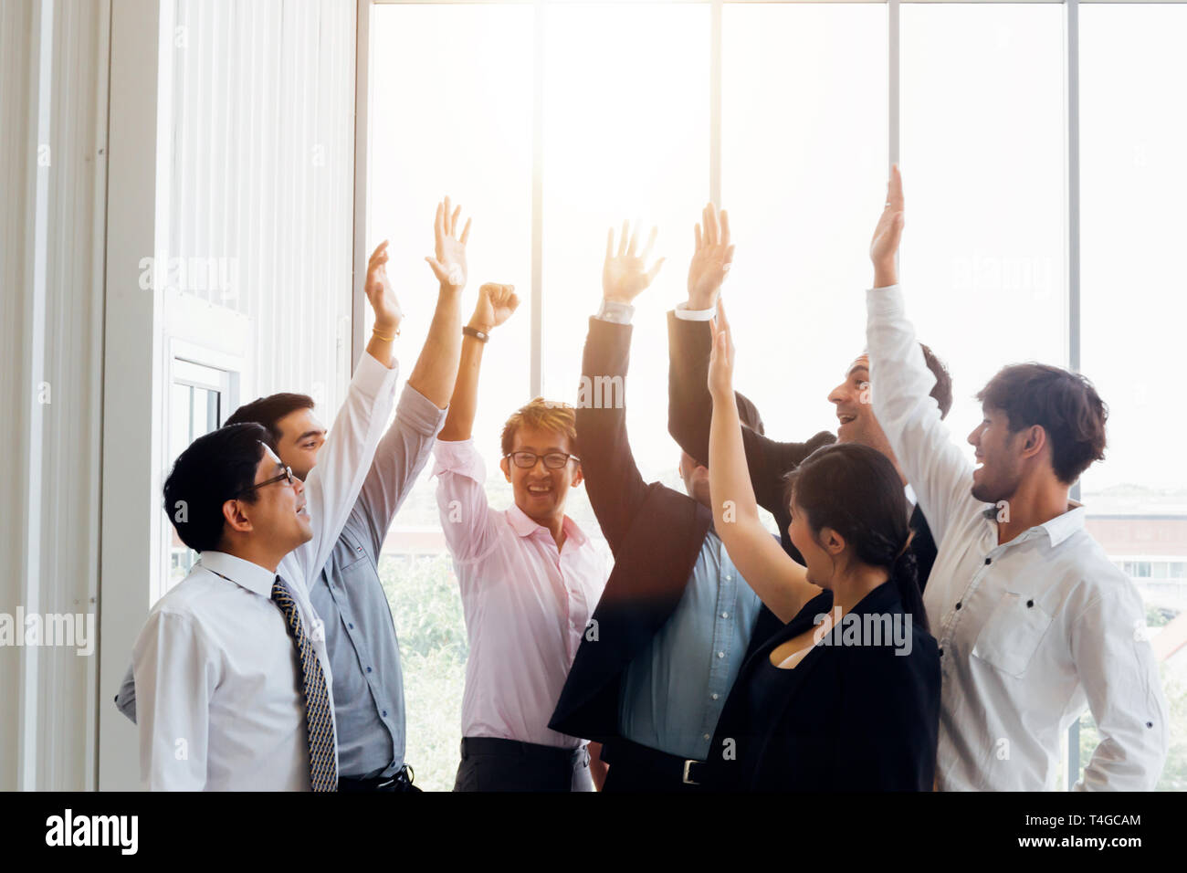 Multiethnic hands raised hi-res stock photography and images - Alamy
