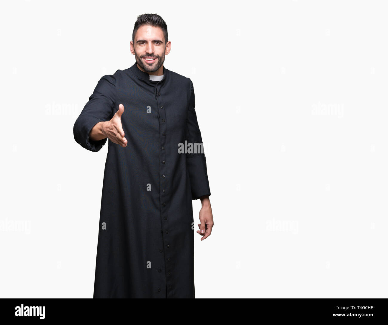 Young Christian priest over isolated background smiling friendly ...