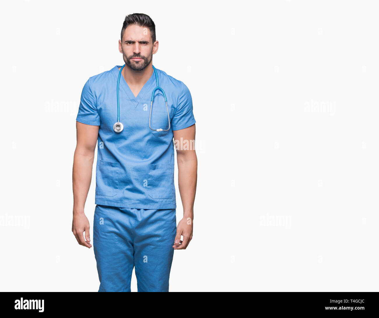 Handsome young doctor surgeon man over isolated background skeptic and ...