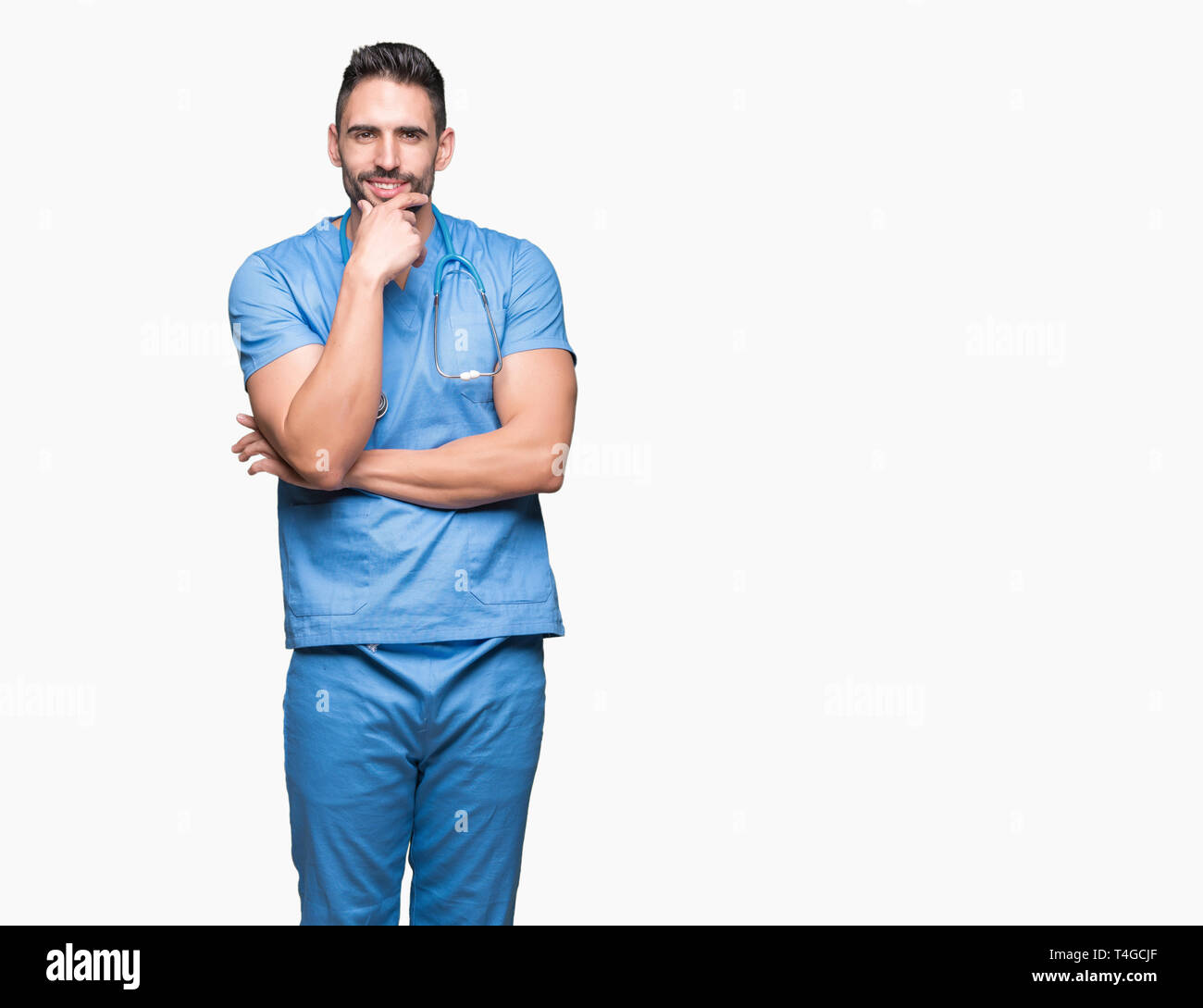 Handsome young doctor surgeon man over isolated background looking ...