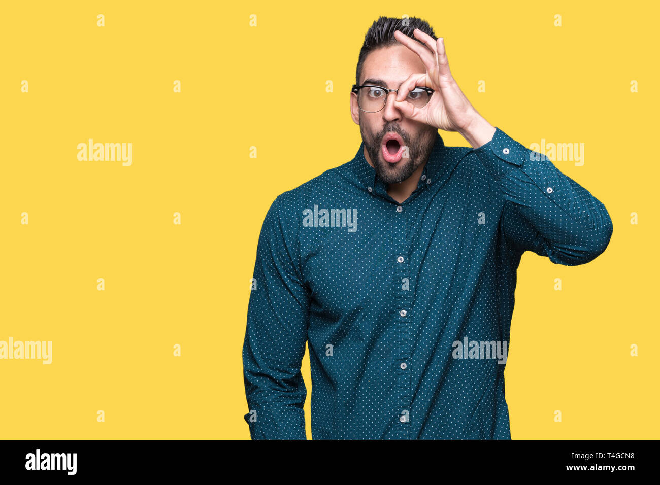 Young handsome business man wearing glasses over isolated background ...