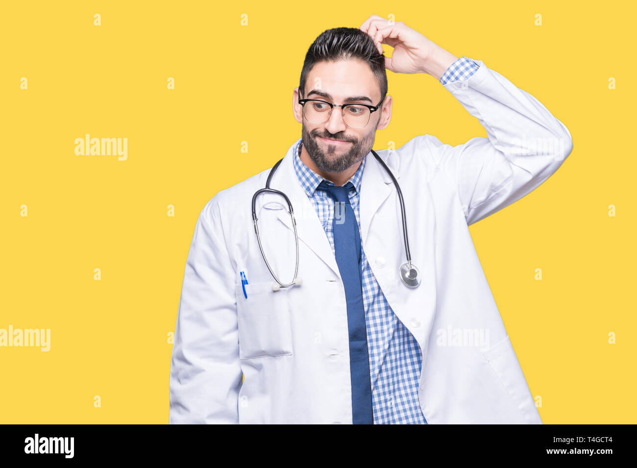 Handsome young doctor man over isolated background confuse and wonder ...