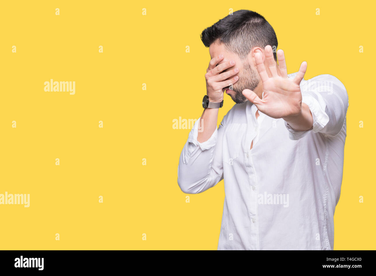Young business man over isolated background covering eyes with hands ...