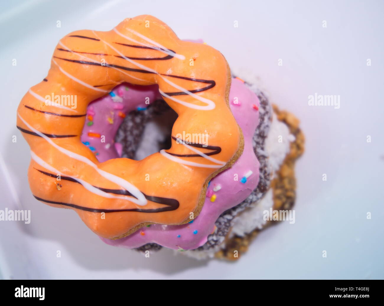 The mix of multicolored sweet doughnuts on a white background Stock ...