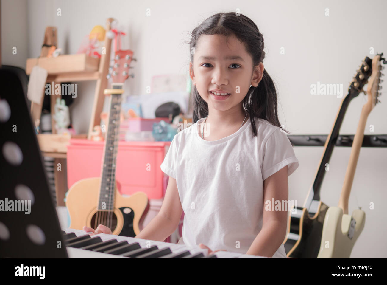 Chinese kids playing musical instrument hi-res stock photography and ...