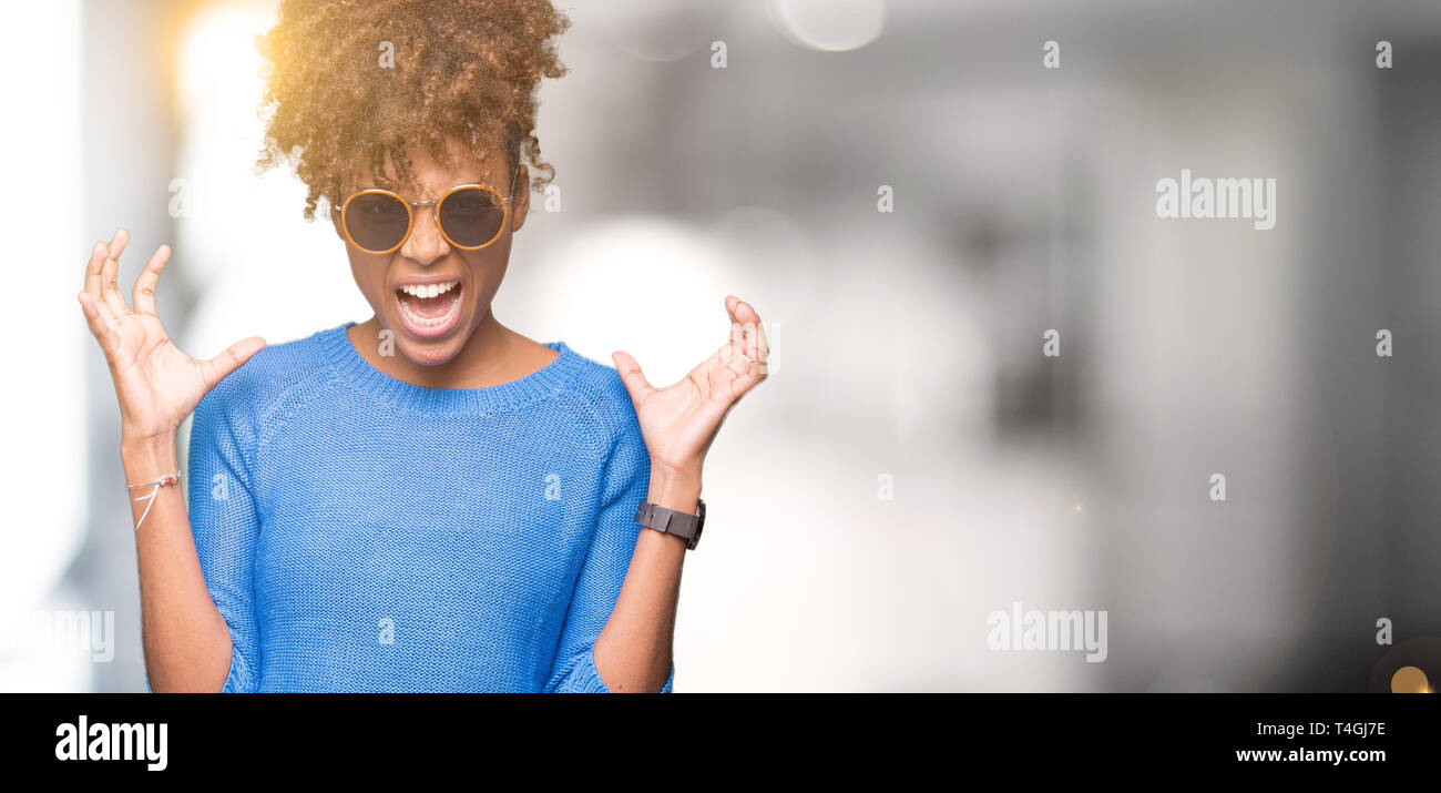 Beautiful young african american woman wearing sunglasses over isolated ...