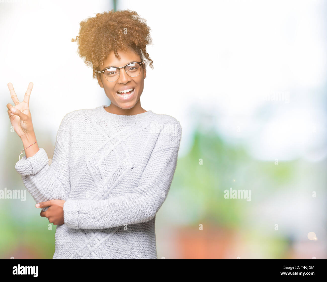 Confident young woman winking smiling hi-res stock photography and ...