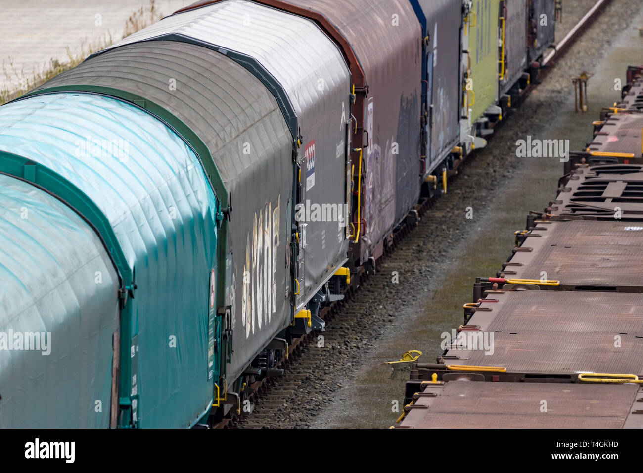 Telephoto recording of a freight wagon on the rails with coloured ...