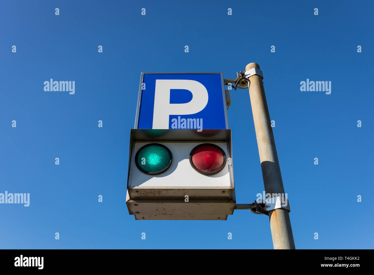 Parking sign at car park entrance with traffic light illuminated green ...