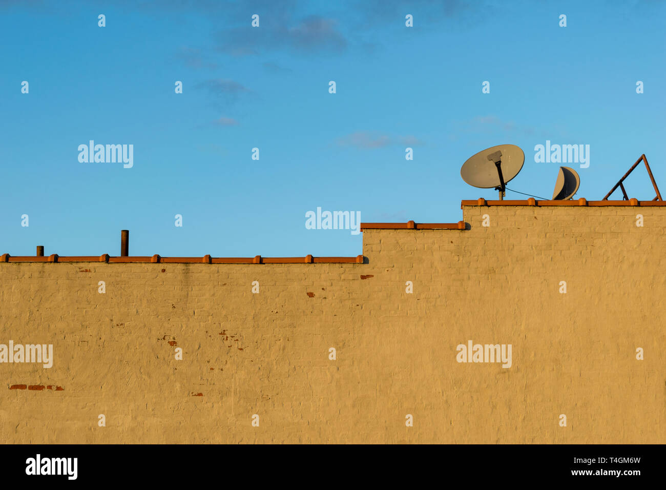 Empty painted brick wall and terracotta clay roofing tile shingles and ...